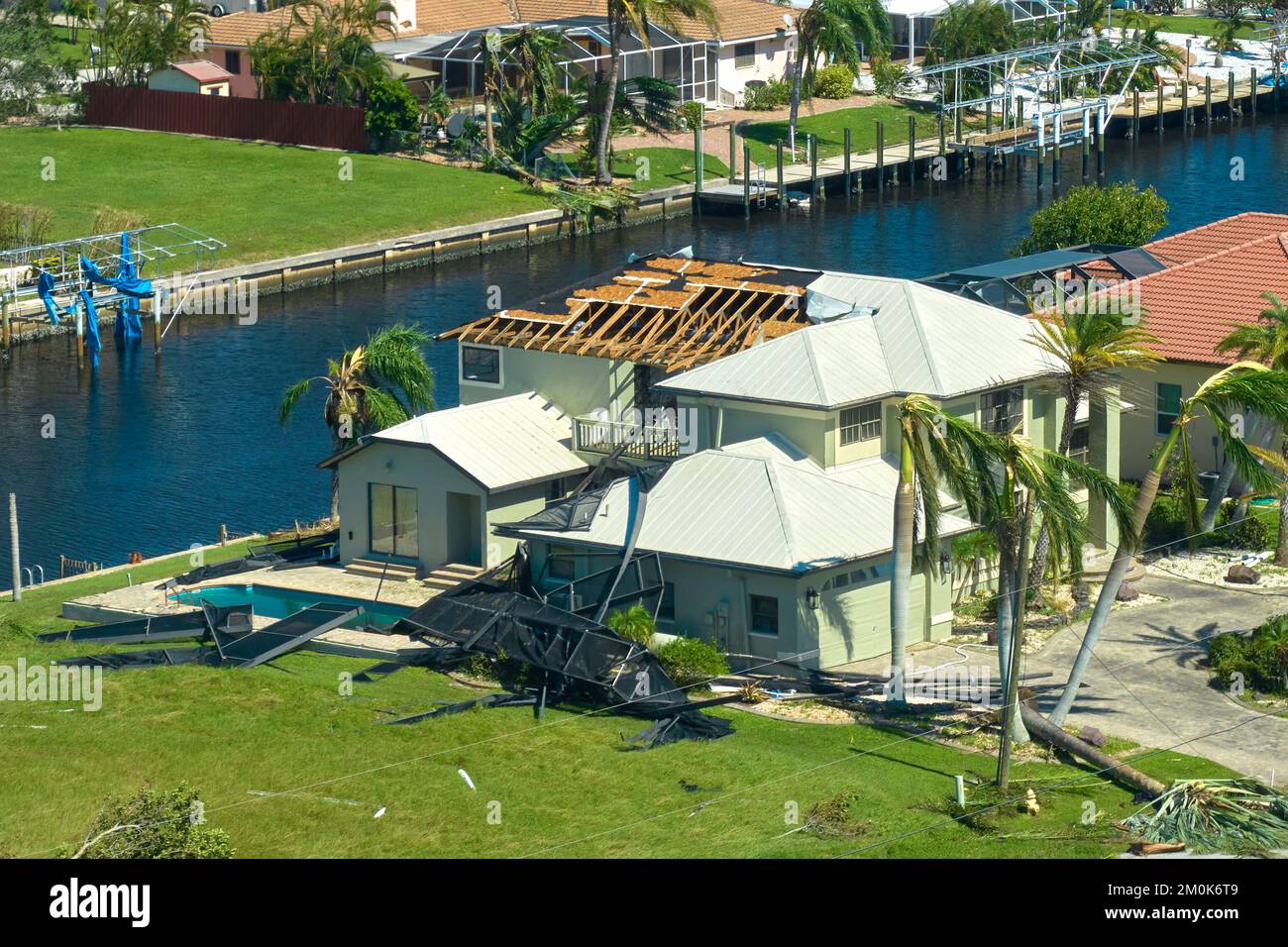 Hurricane Ian destroyed house roof in Florida residential area. Natural ...