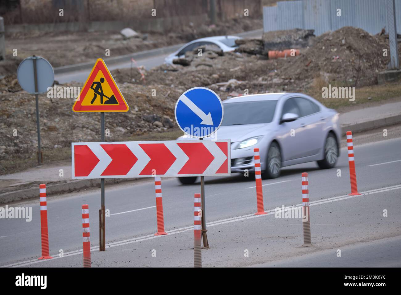 Roadworks warning traffic signs of construction work on city street and ...