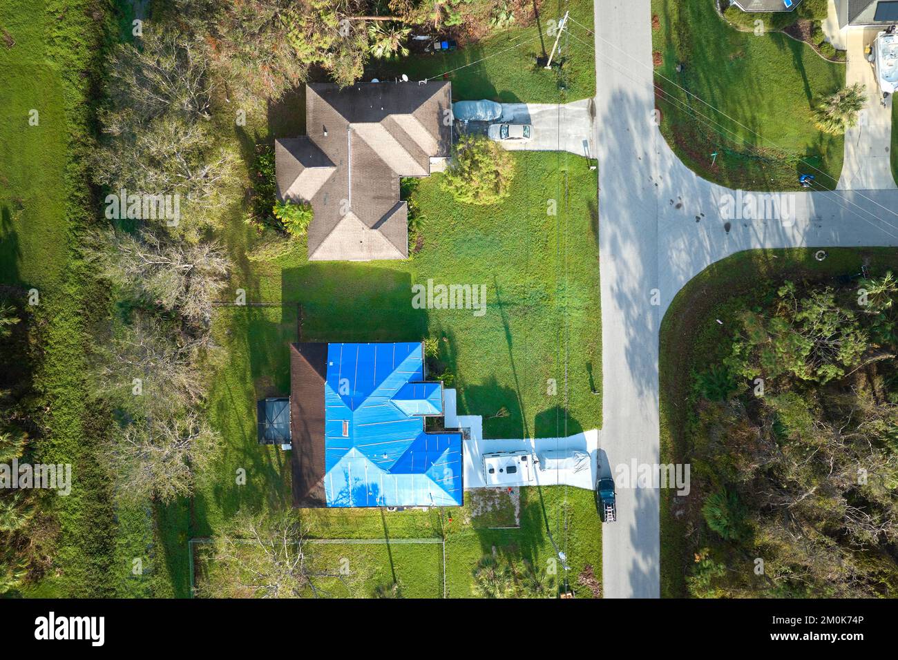 Top view of leaking house roof covered with protective tarp sheets ...