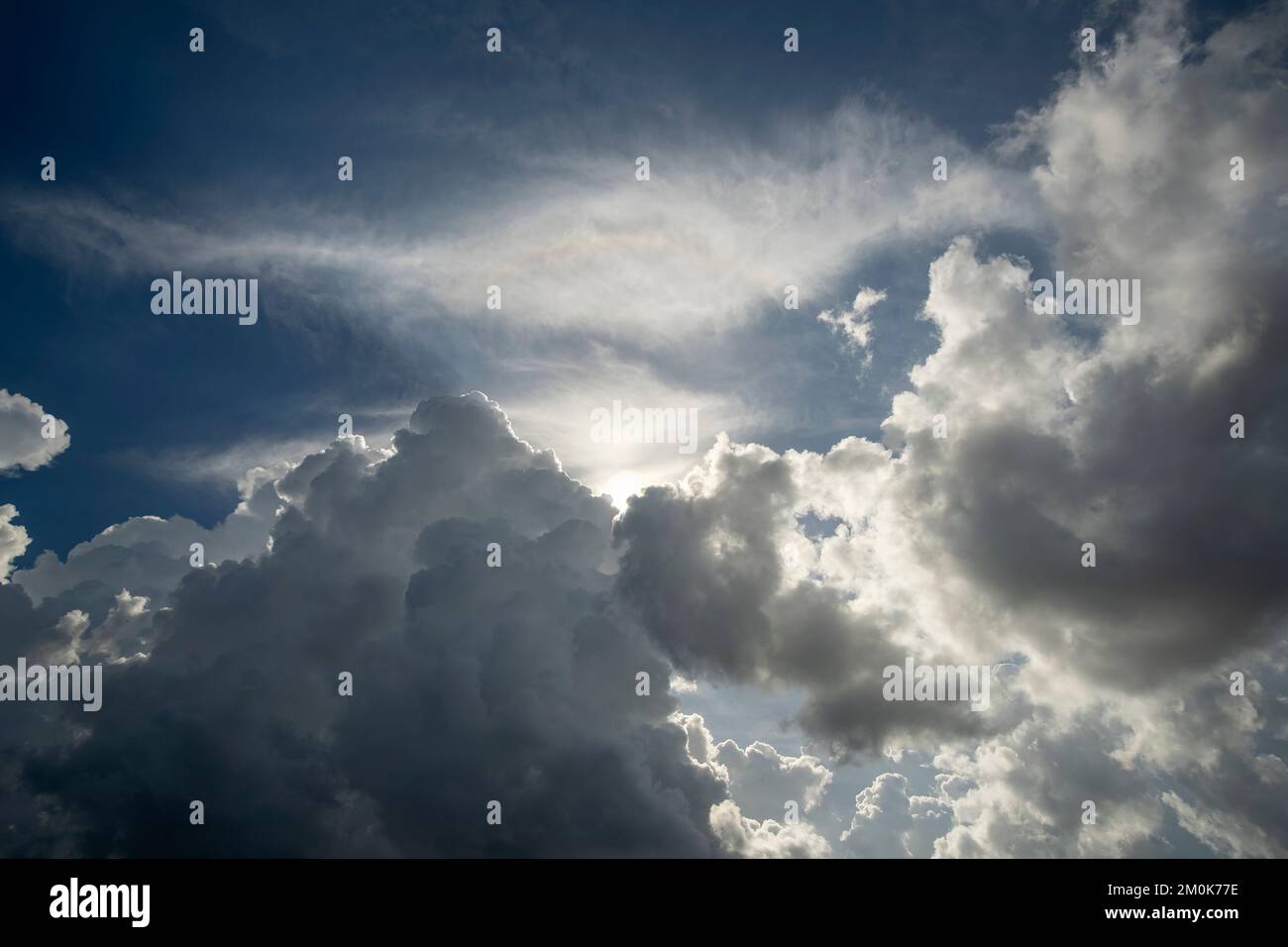 White fluffy cumulonimbus clouds forming before thunderstorm on summer ...