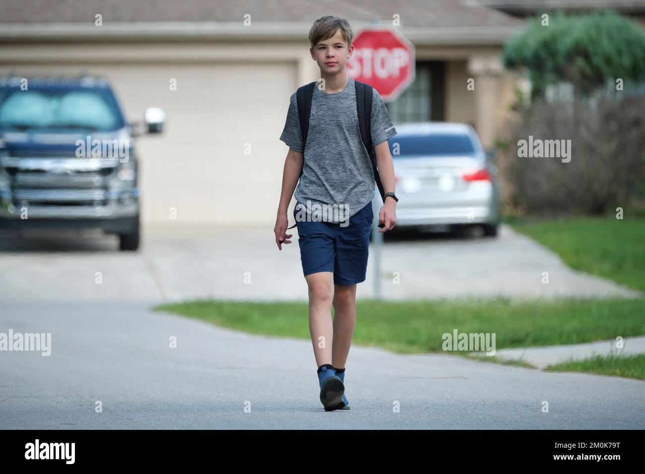 Young handsome smiling teenager boy with backpack happy going to school ...