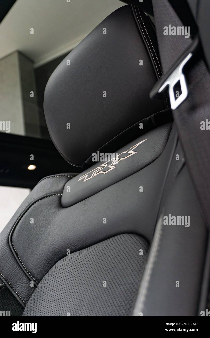 A vertical shot of a black leather seat with a TRX stitching Stock ...