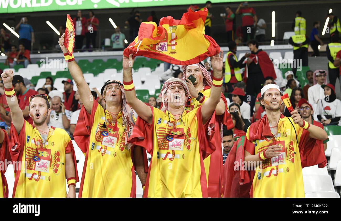 Spain fans wearing flag-themed thobes cheer in the stands ahead of a ...