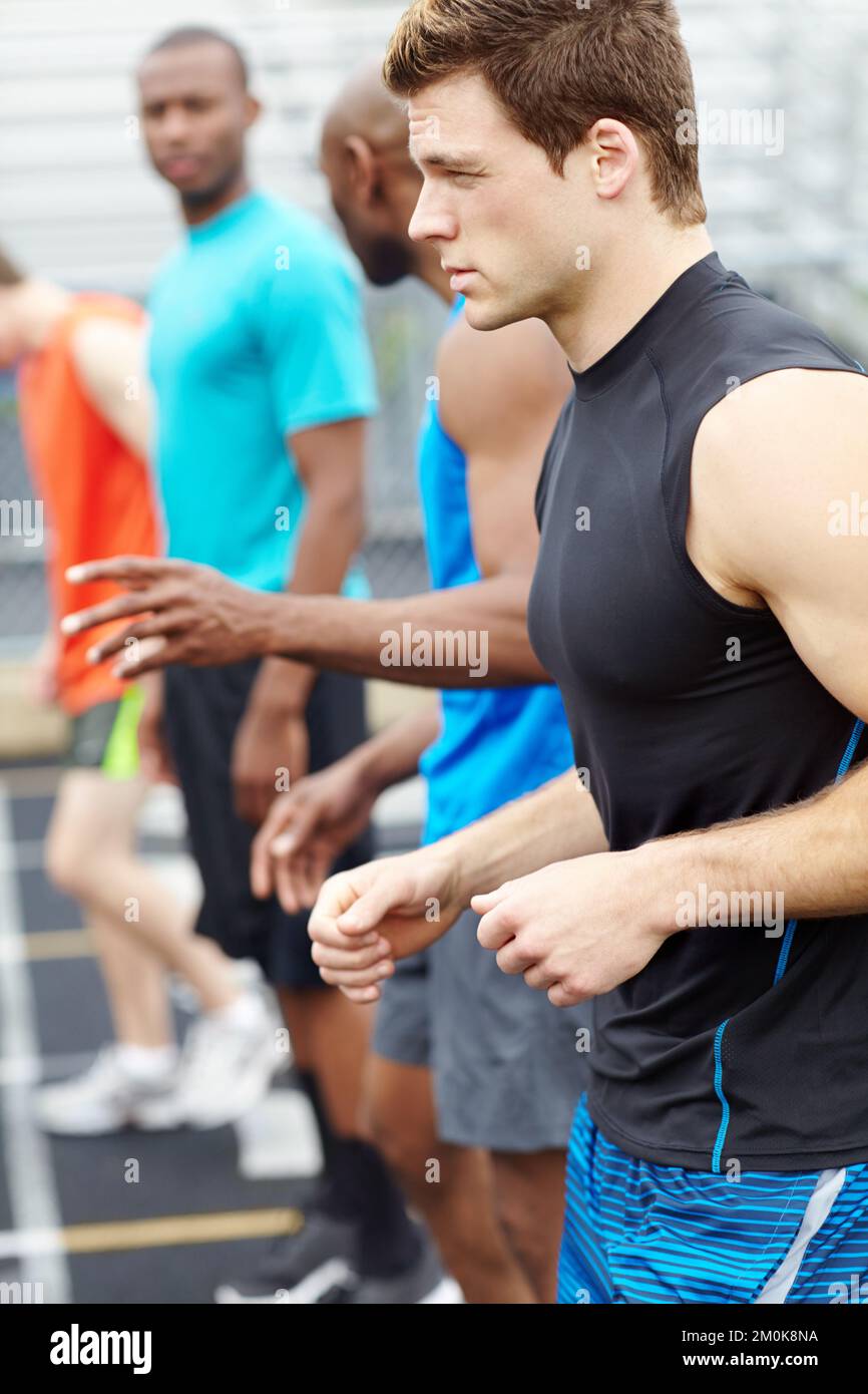 He only sees the finish line. Side view of a line up of runners at the ...