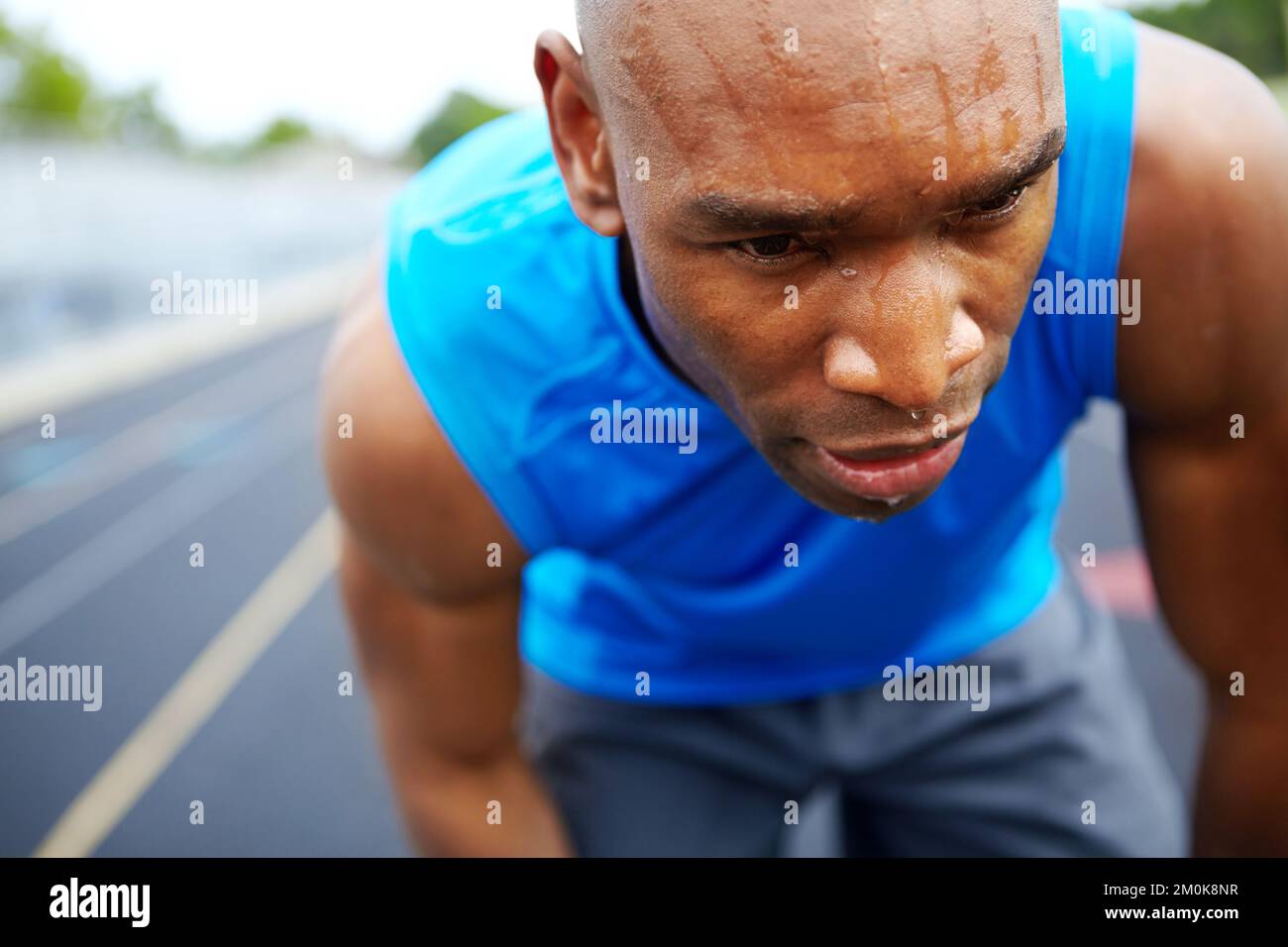He gave it his all. Cropped close up of a male athlete getting into the ...