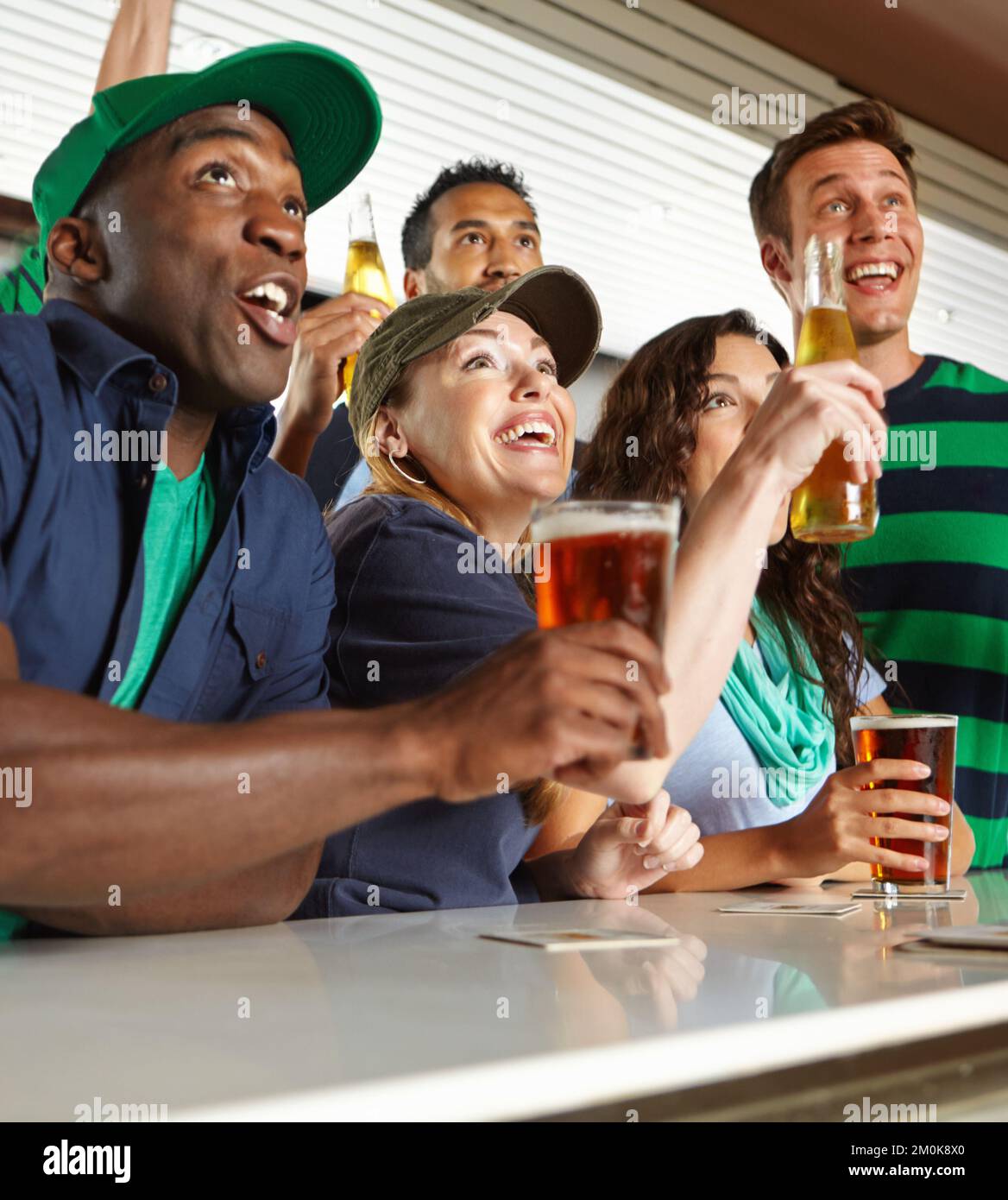 What a game. A group of friends cheering on their favourite sports team ...