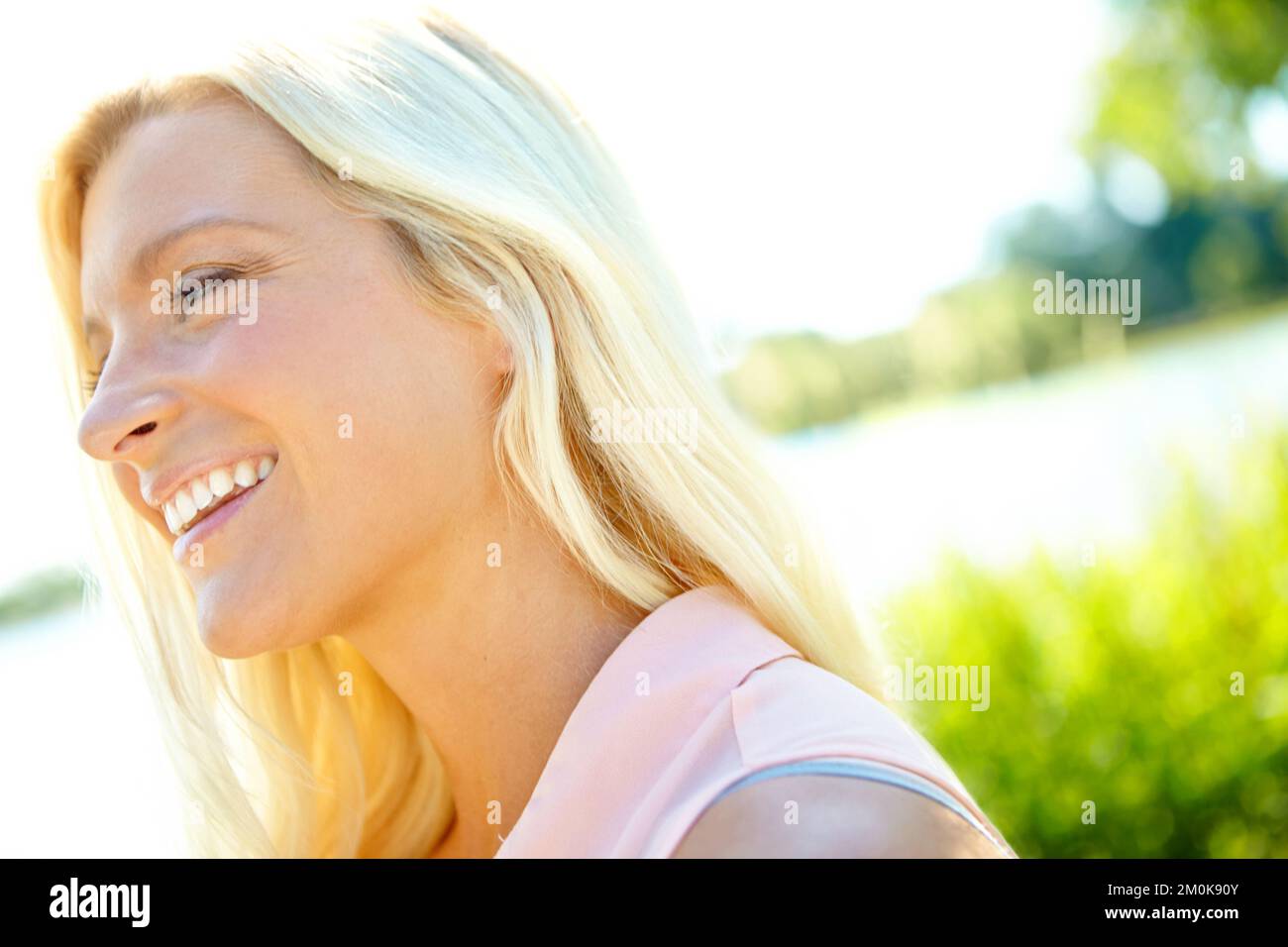 Naturally gorgeous. Profile of a beautiful blonde outside with ...