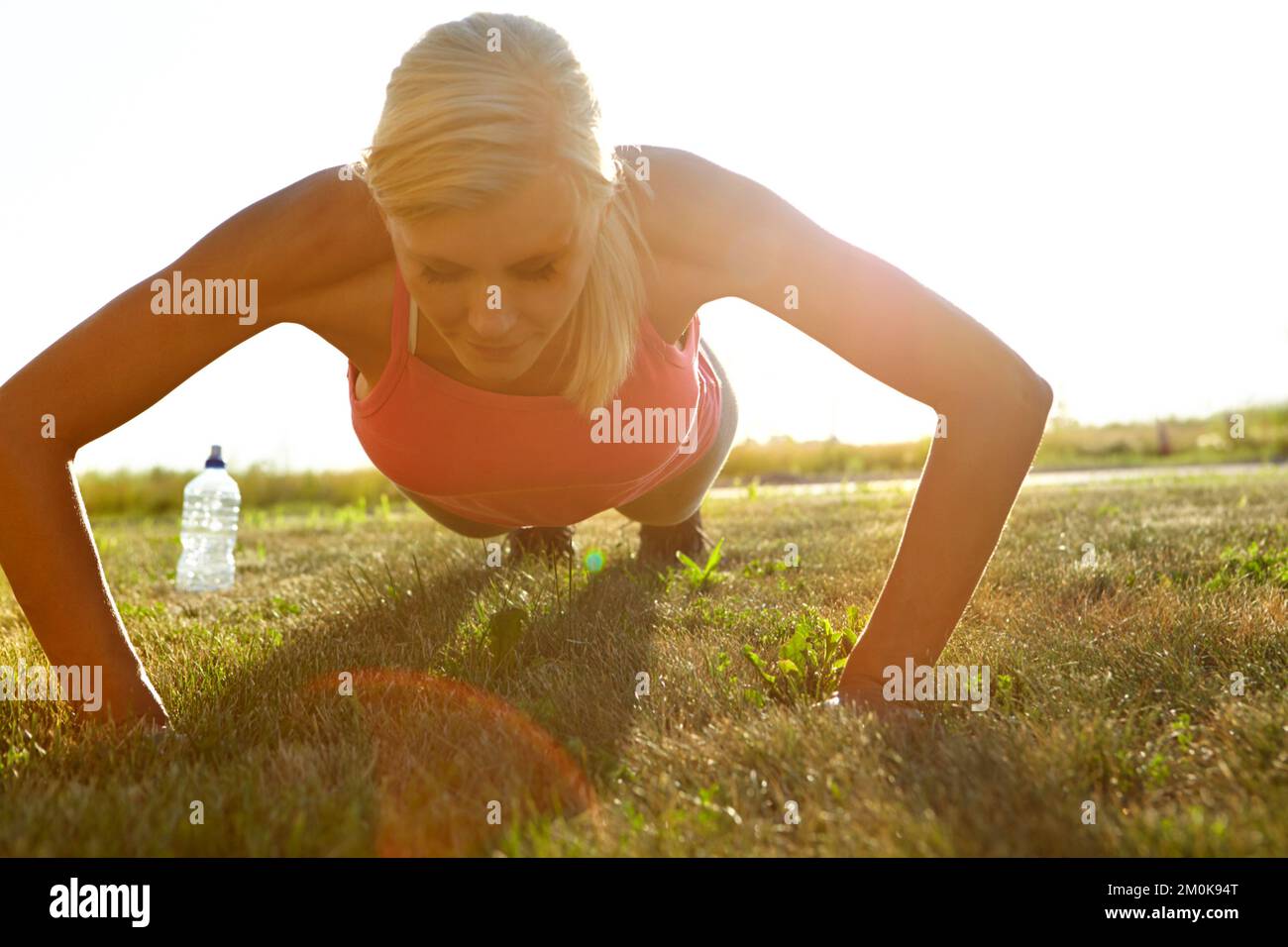 Ensuring that every muscle gets toned. A young woman doing push-ups in ...