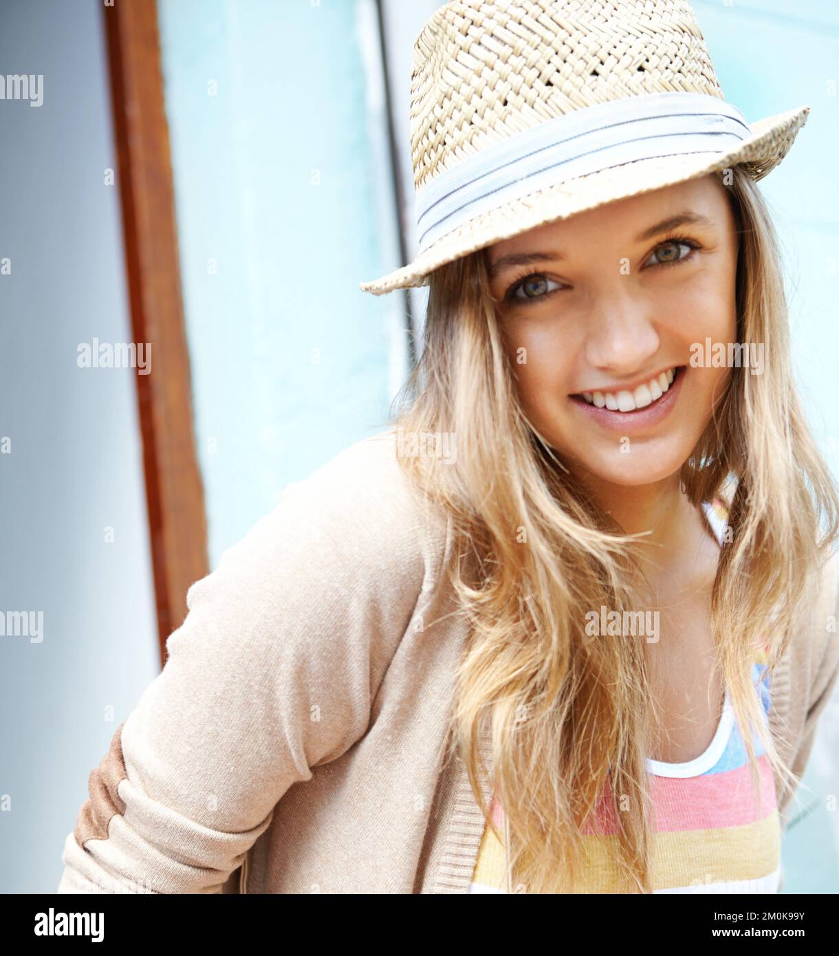 Casual charm. Closeup of a beautiful young woman wearing a sunhat and ...
