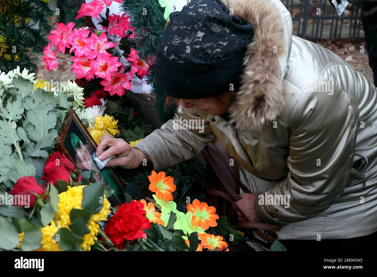 KHARKIV, UKRAINE - DECEMBER 6, 2022 - A relative grieves at the photo ...