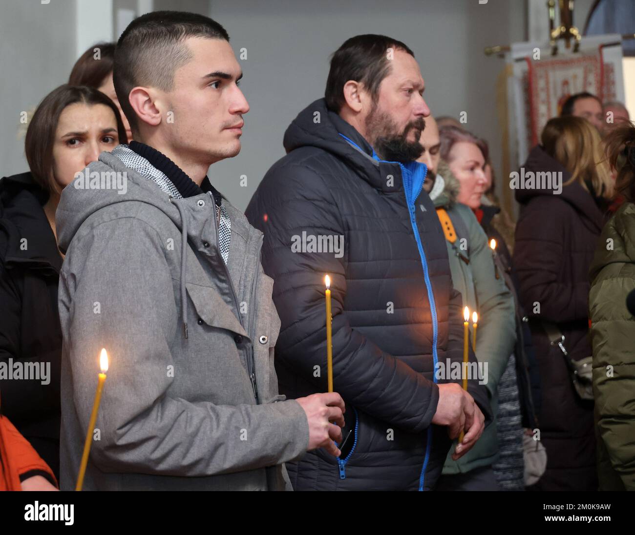 KHARKIV, UKRAINE - DECEMBER 6, 2022 - Attendees hold burning candles ...