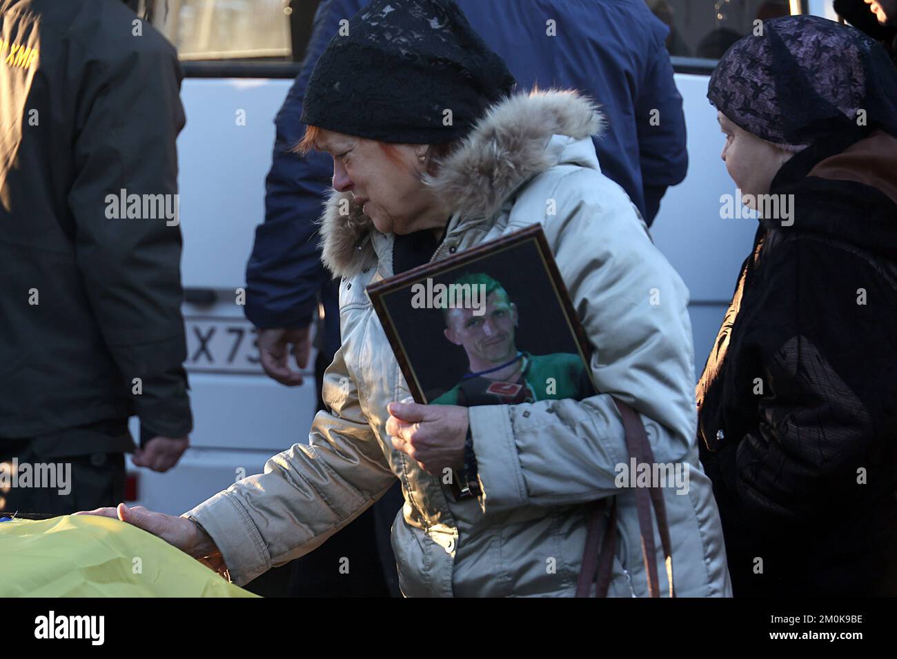 KHARKIV, UKRAINE - DECEMBER 6, 2022 - A relative grieves at the coffin with the body of ...