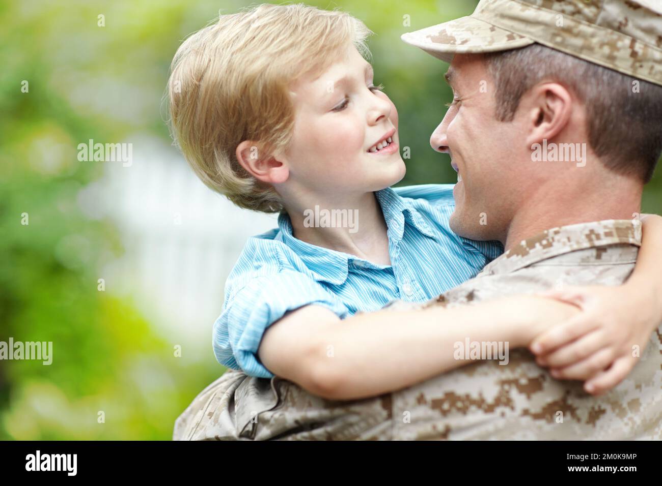 Its so good to be home. A father back from the army holding his son as ...