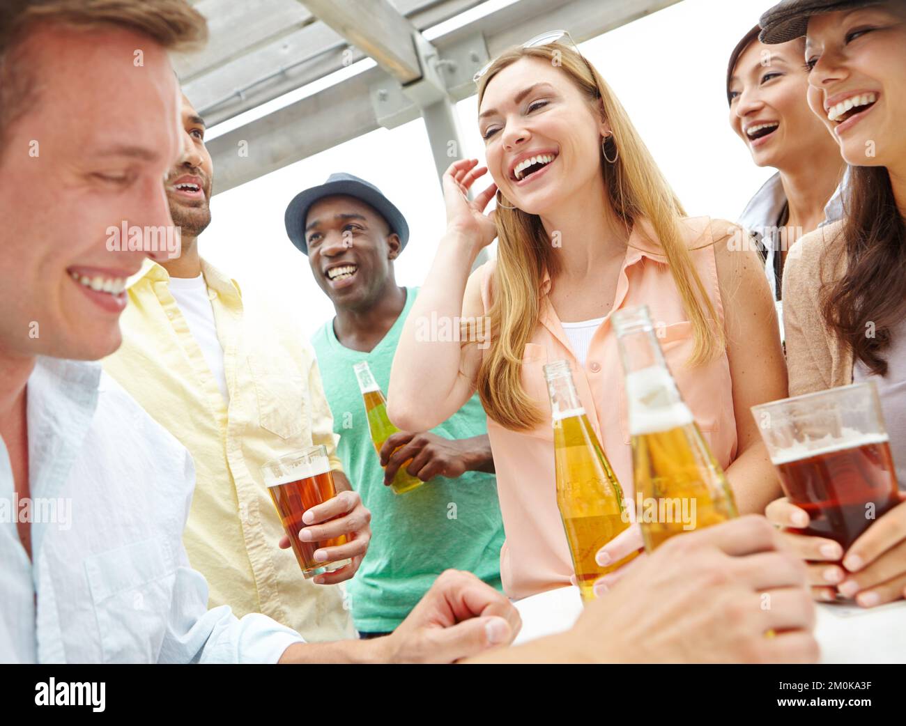Drinks and laughter. A group of friends drinking and having a good time at a restaurant Stock ...