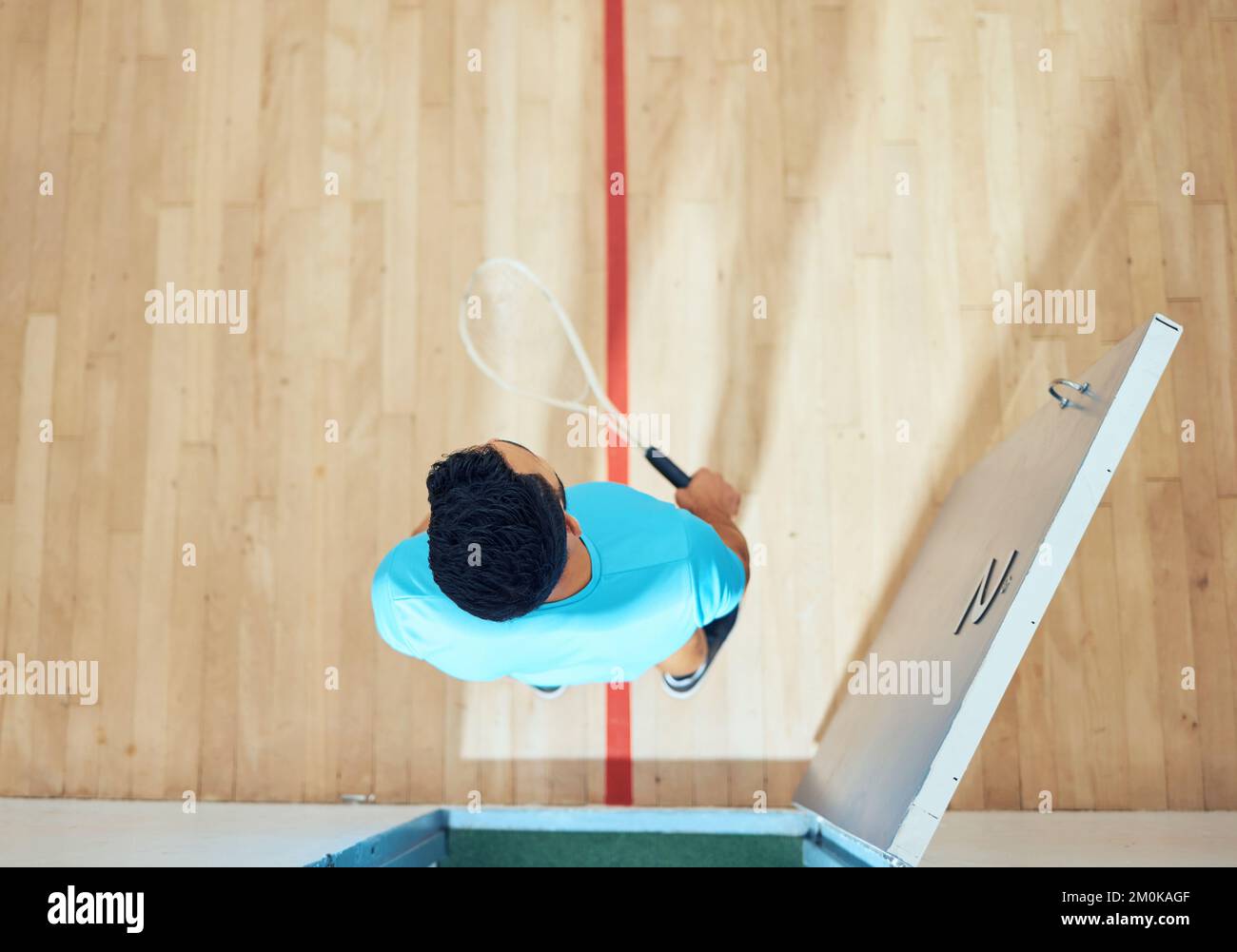 Above view of unknown athletic squash player standing alone before ...