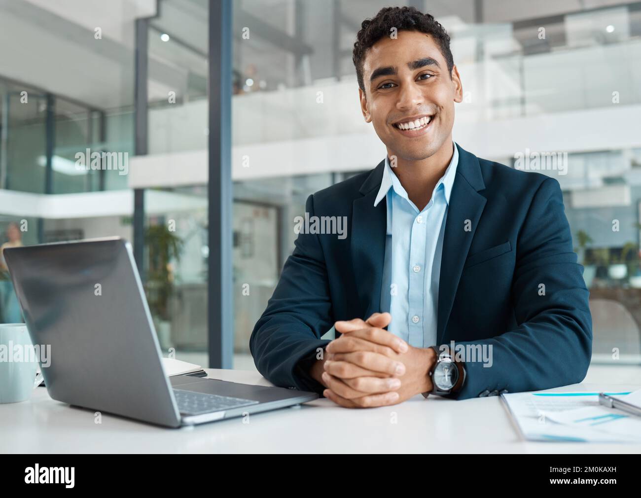 Young happy mixed race businessman looking ready for the day while ...
