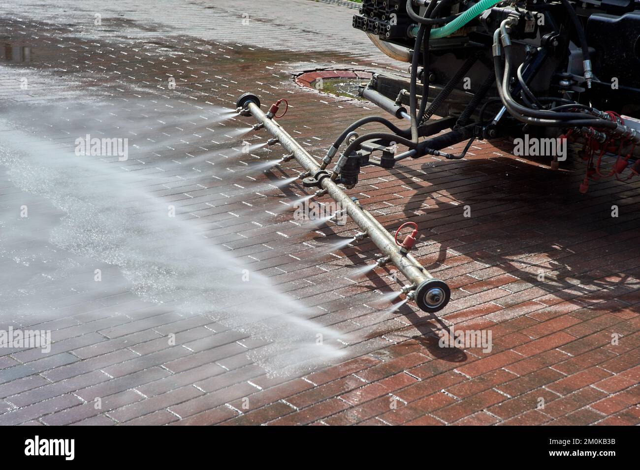 A special machine washes city paths and roads with water Stock Photo ...