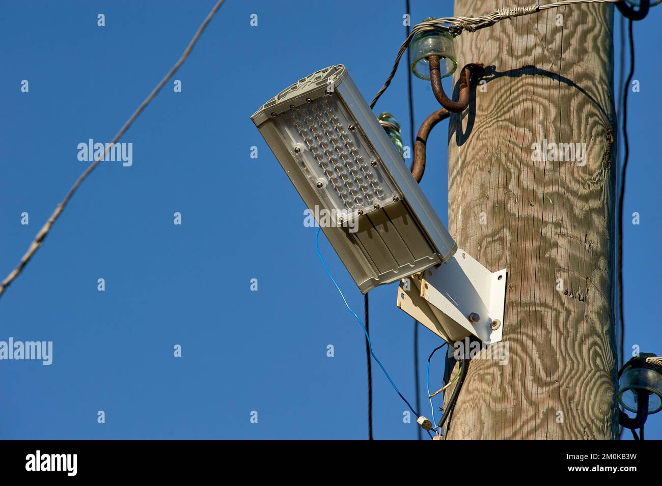 The LED street light is attached to a wooden pole Stock Photo - Alamy