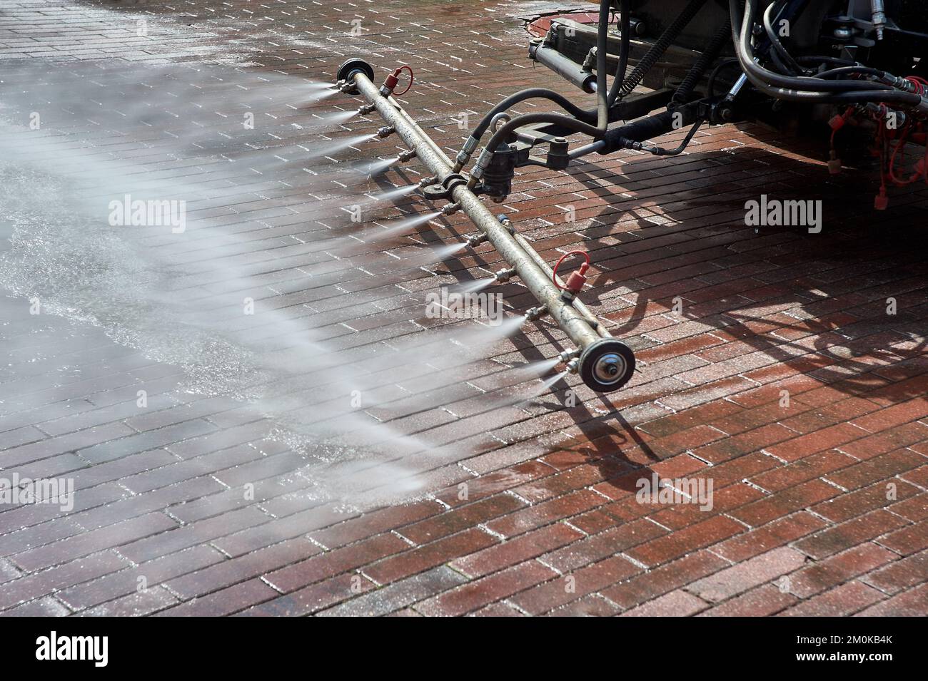 A special machine washes city paths and roads with water Stock Photo ...