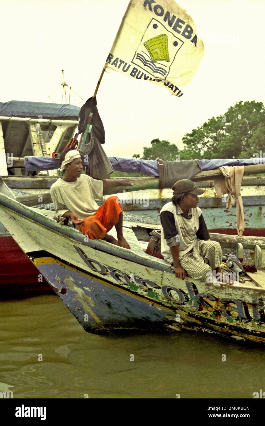 Fishermen sitting on a boat during a relax time in Sumur, a fishing ...