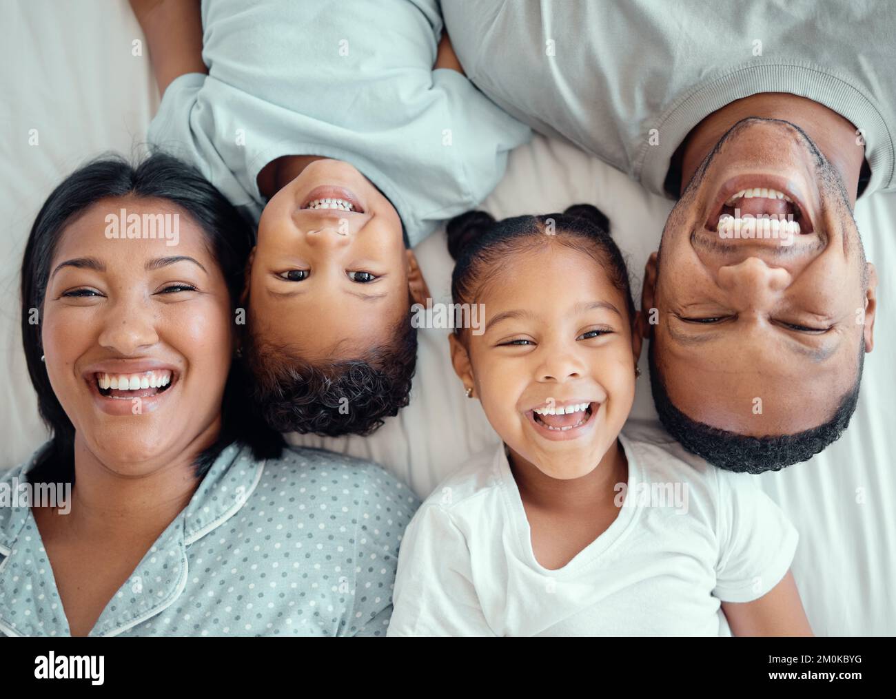 Portrait of happy funny mixed race family with two children relaxing ...