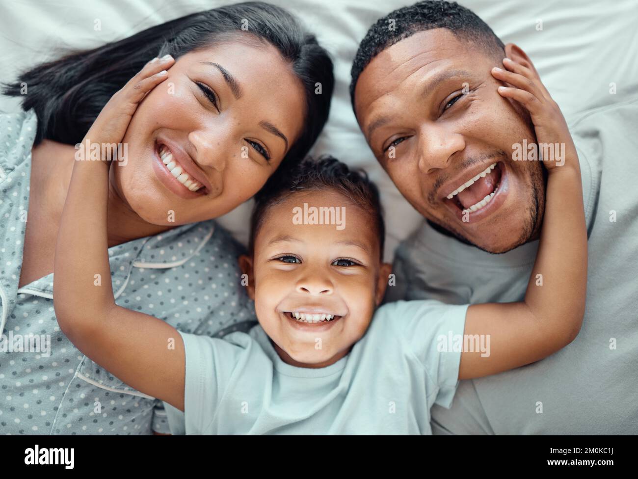 Portrait of adorable little boy with his hands on his parents paces ...