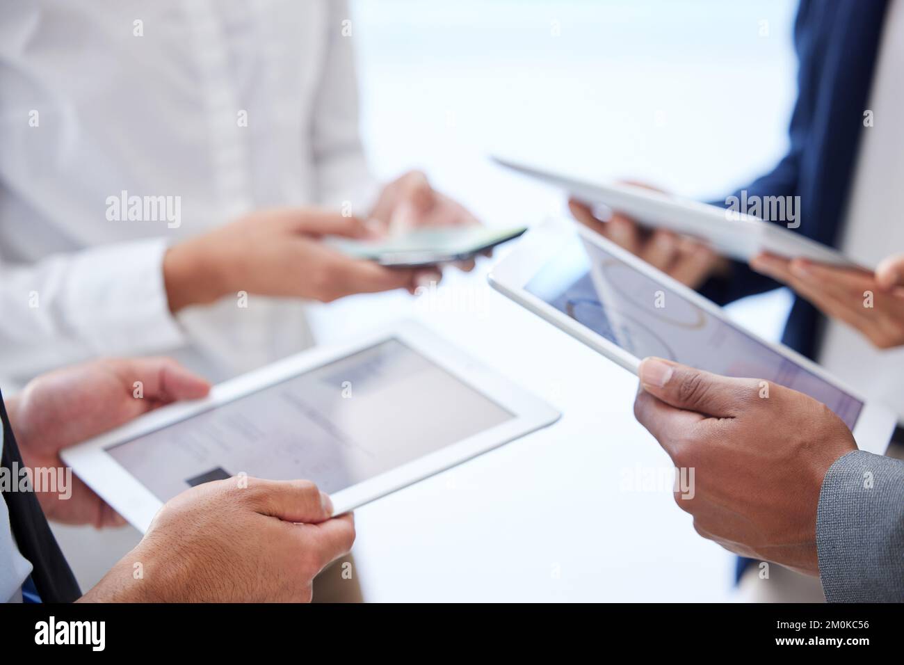 Unknown group of diverse businesspeople using technology in office ...