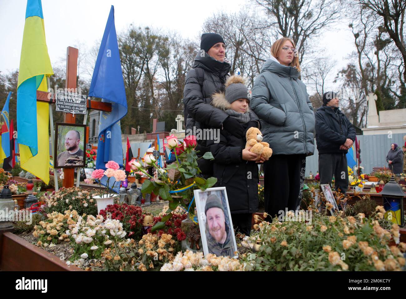 KYIV, UKRAINE - DECEMBER 6, 2022 - A woman with children stands among ...