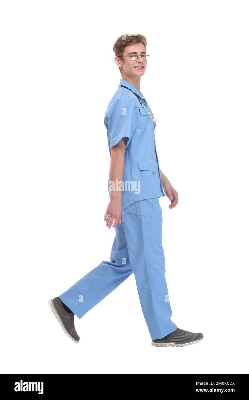 Full length studio shot of walking young male doctor with stethoscope ...