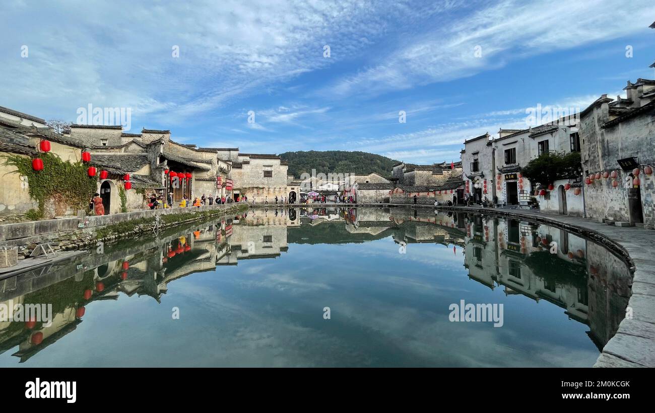 A beautiful scene of rural houses reflecting on lake water in Tachuan ...