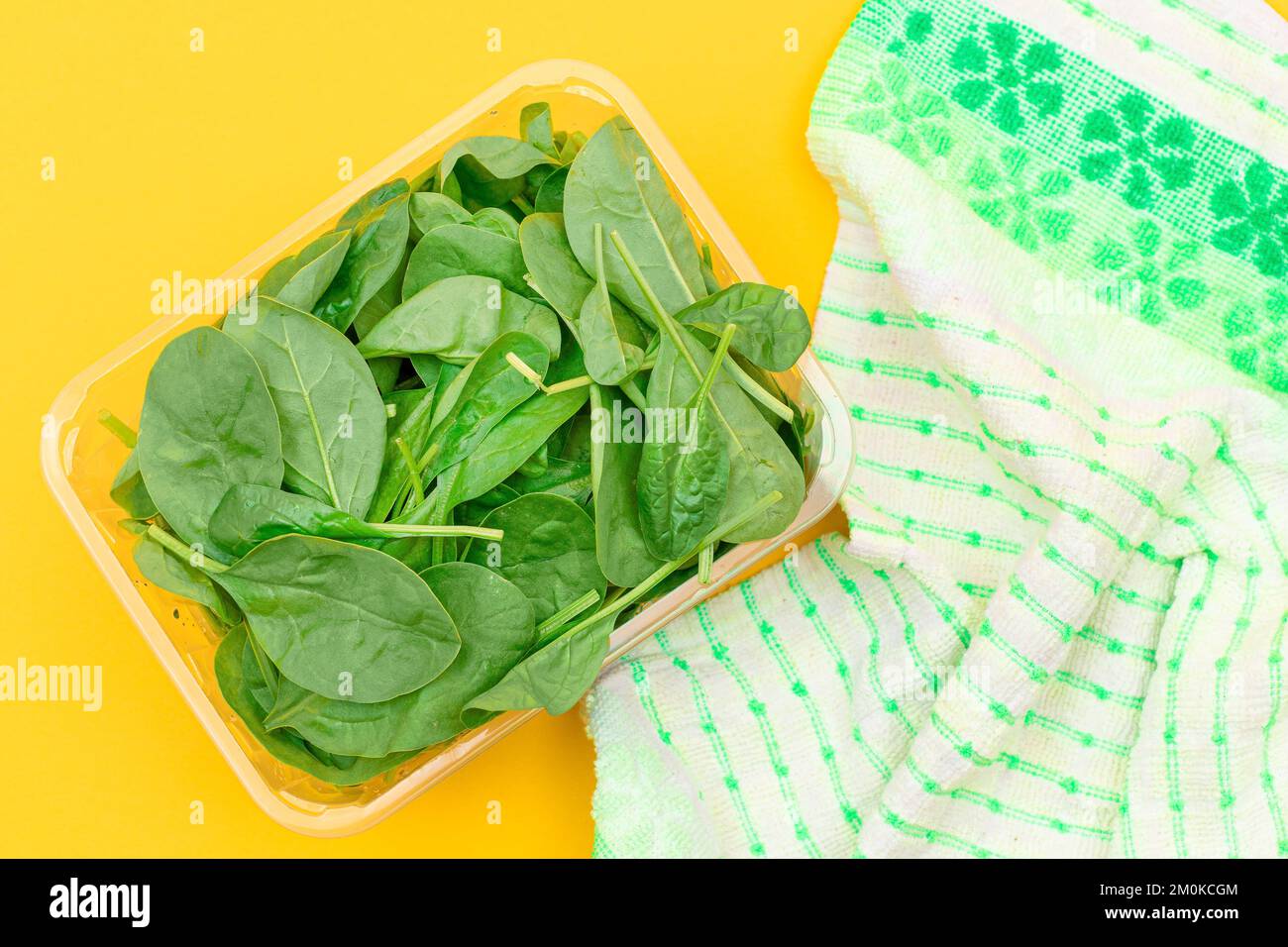 Fresh Baby Spinach Leaves in Transparent Plastic Package on Yellow ...
