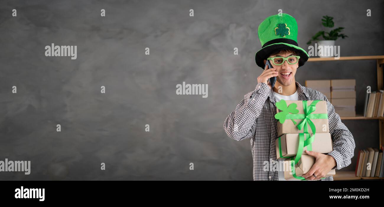 St. patrick's day sale, festive online shopping, young man in ...