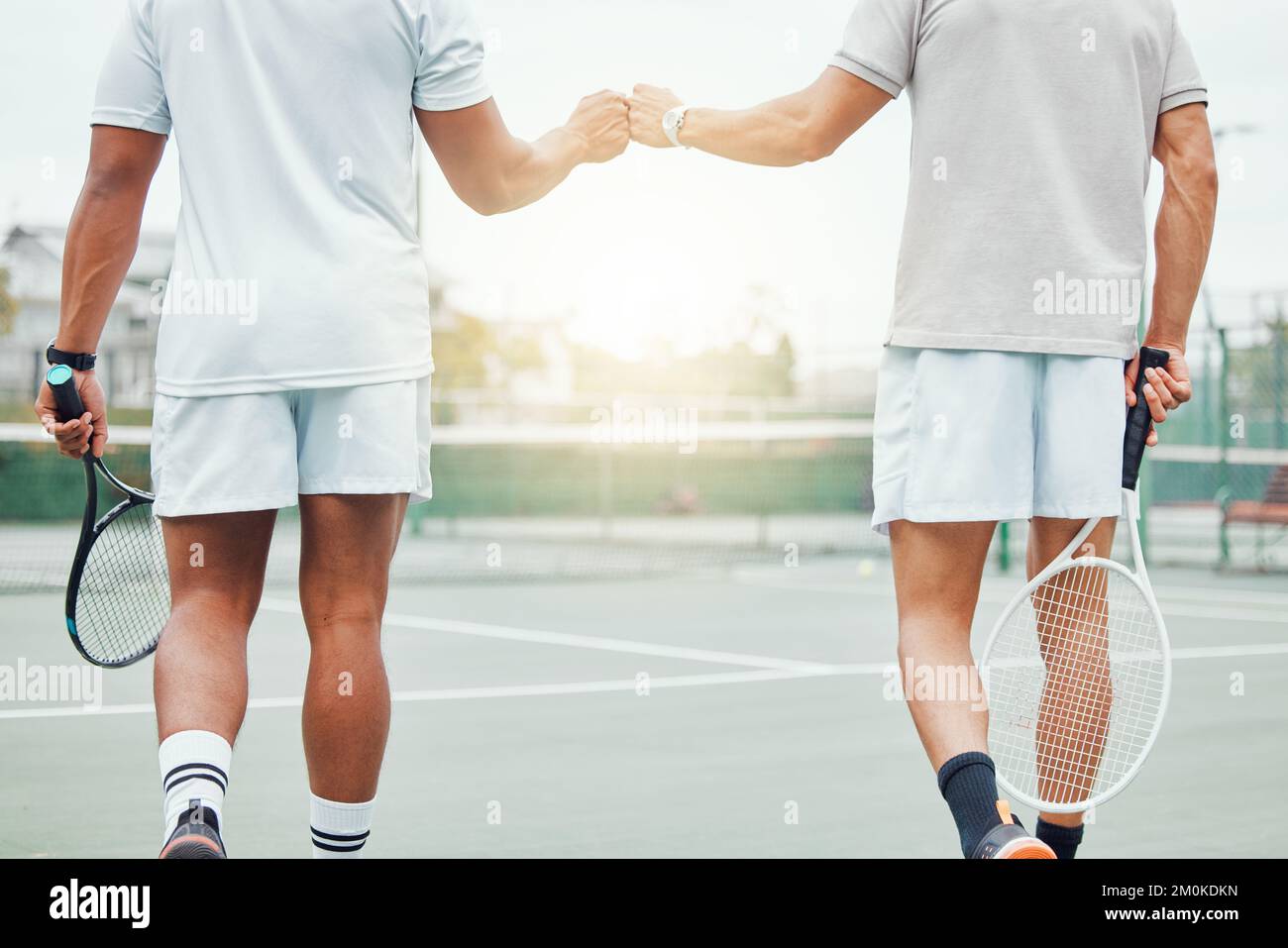Two unknown ethnic tennis players giving fistbump with fist before ...