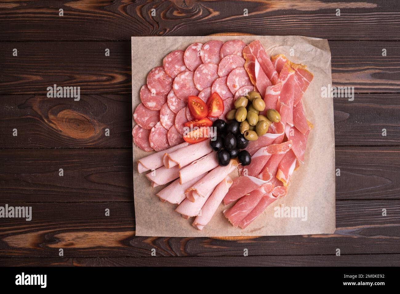 Meat catering platter with olives and red tomatoes, top view. Copy ...