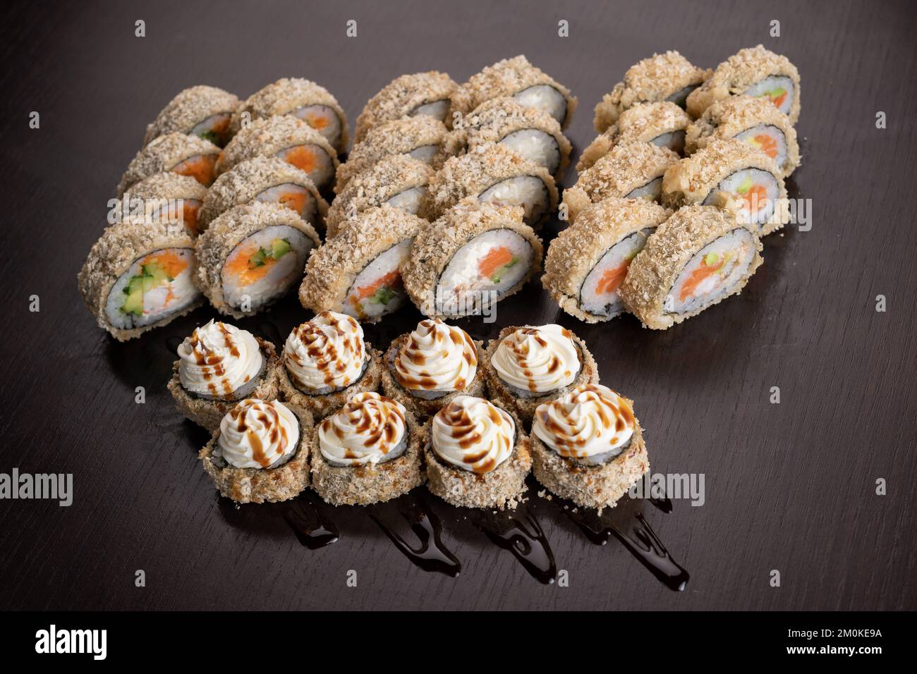 Tempura maki roll on black background. Hot sushi set with salmon, crab ...