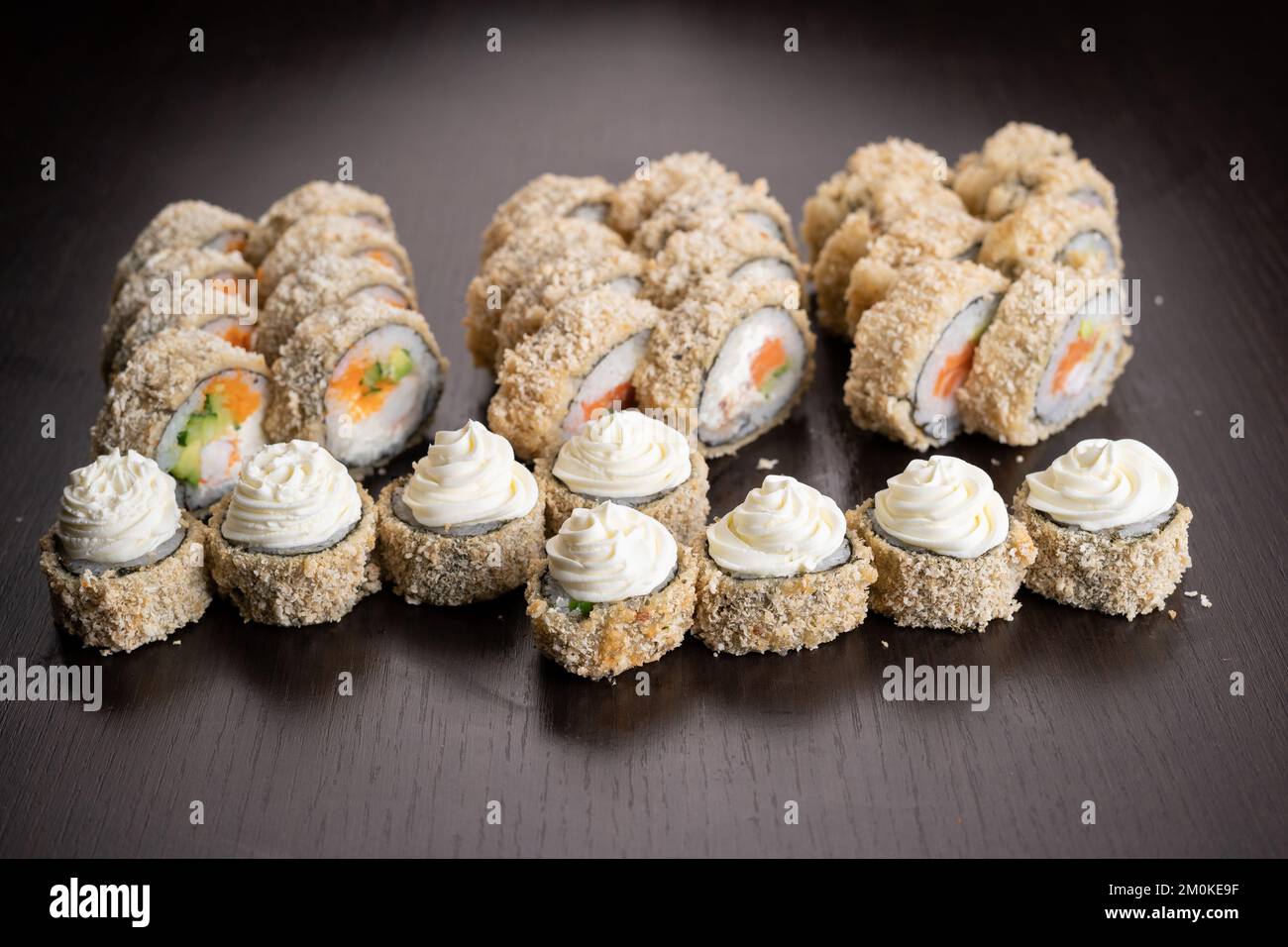 Hot tempura sushi set with cream cheese on black background with ...