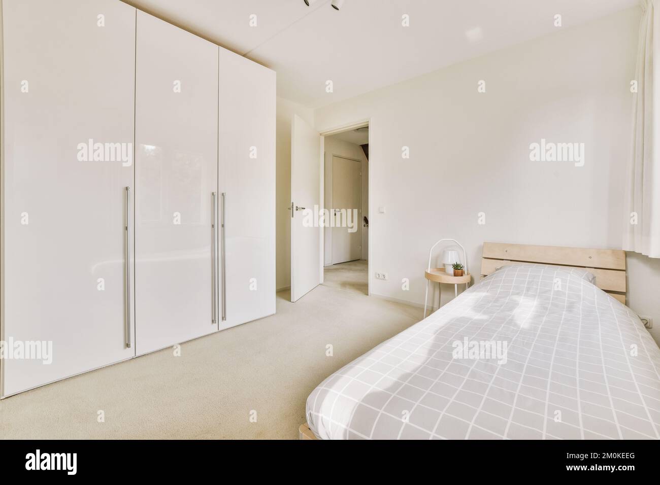 Home interior design of bedroom with bed and wooden wardrobe placed in ...