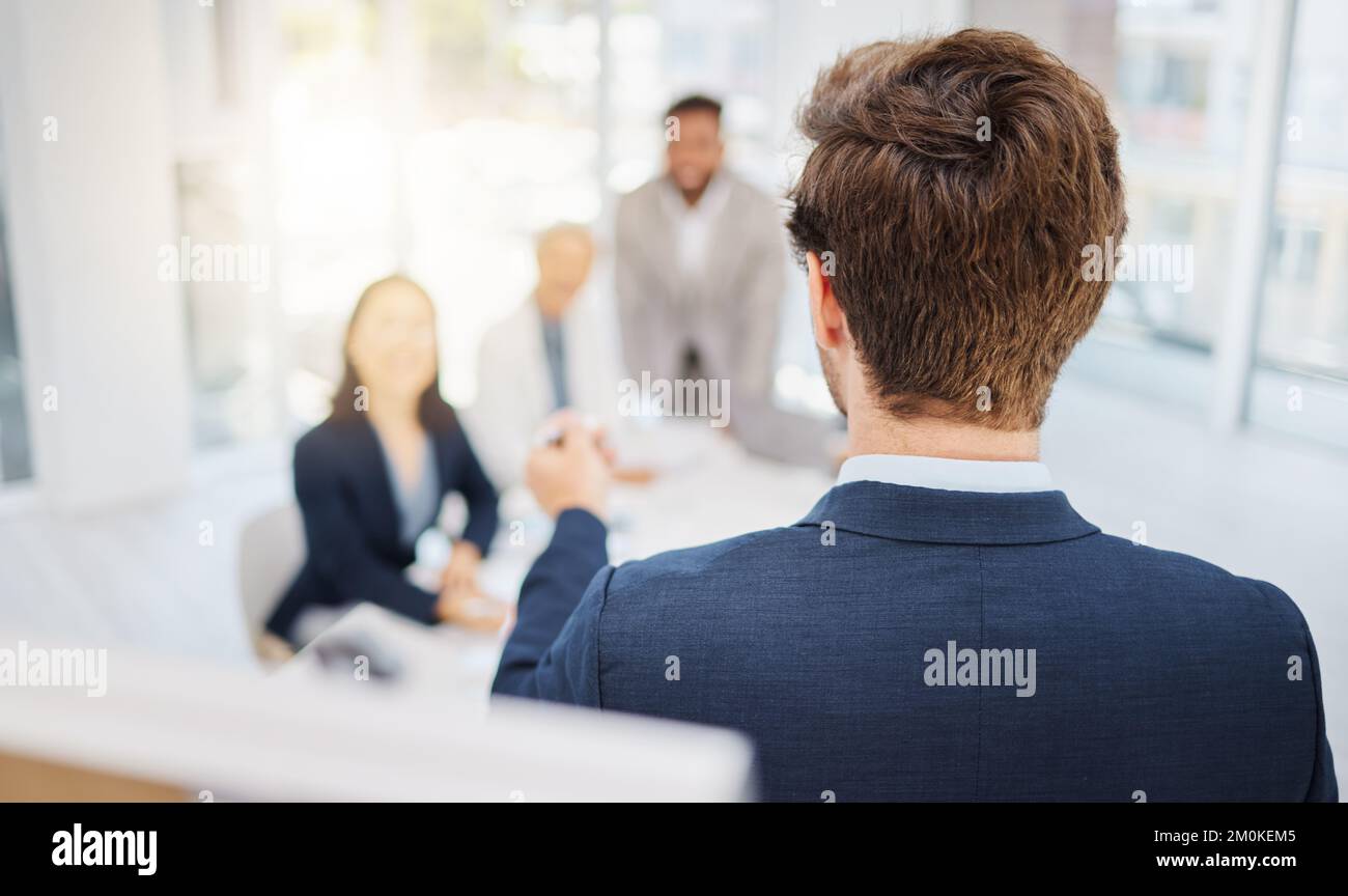 High angle of one young caucasian businessman from the back using a ...