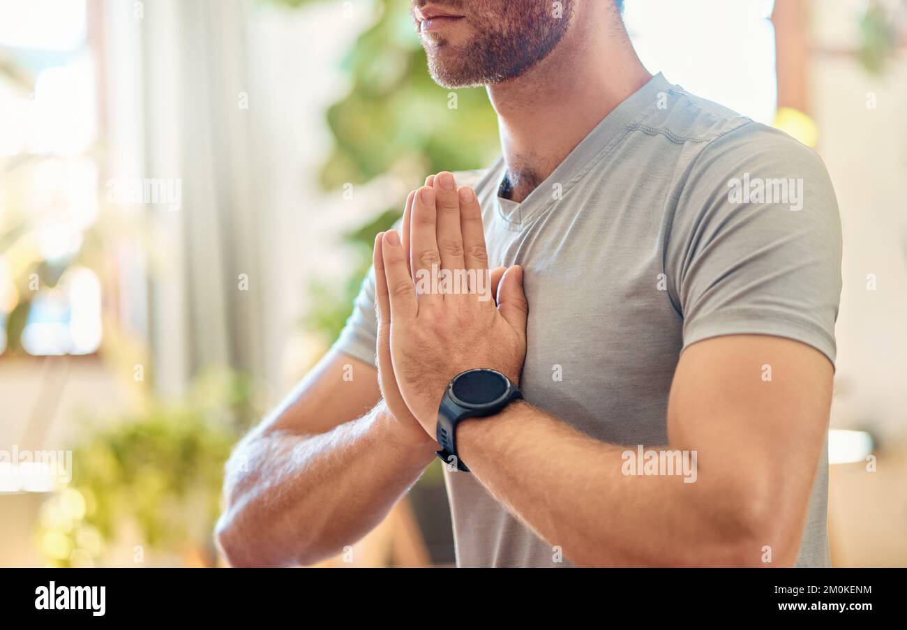 Closeup of one caucasian man meditating in harmony with hands together ...