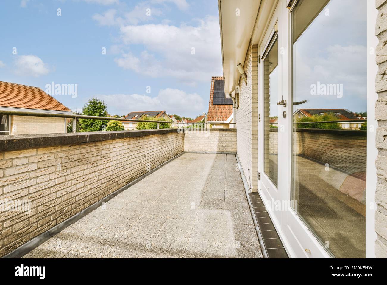 Narrow brick balcony with metal railings and door Stock Photo - Alamy