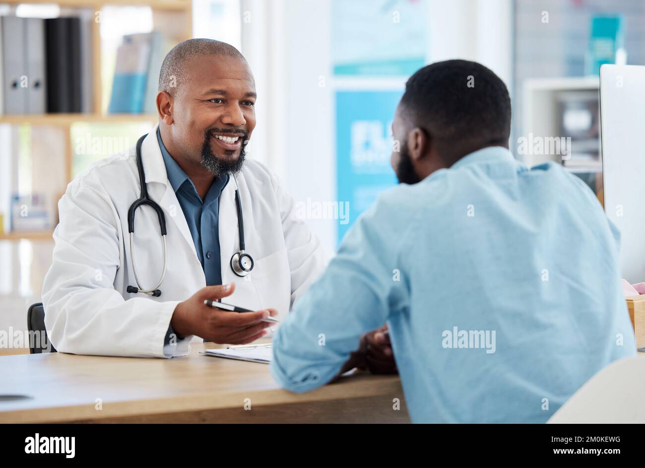 Medical physician talking to his patient. African american patient in a ...