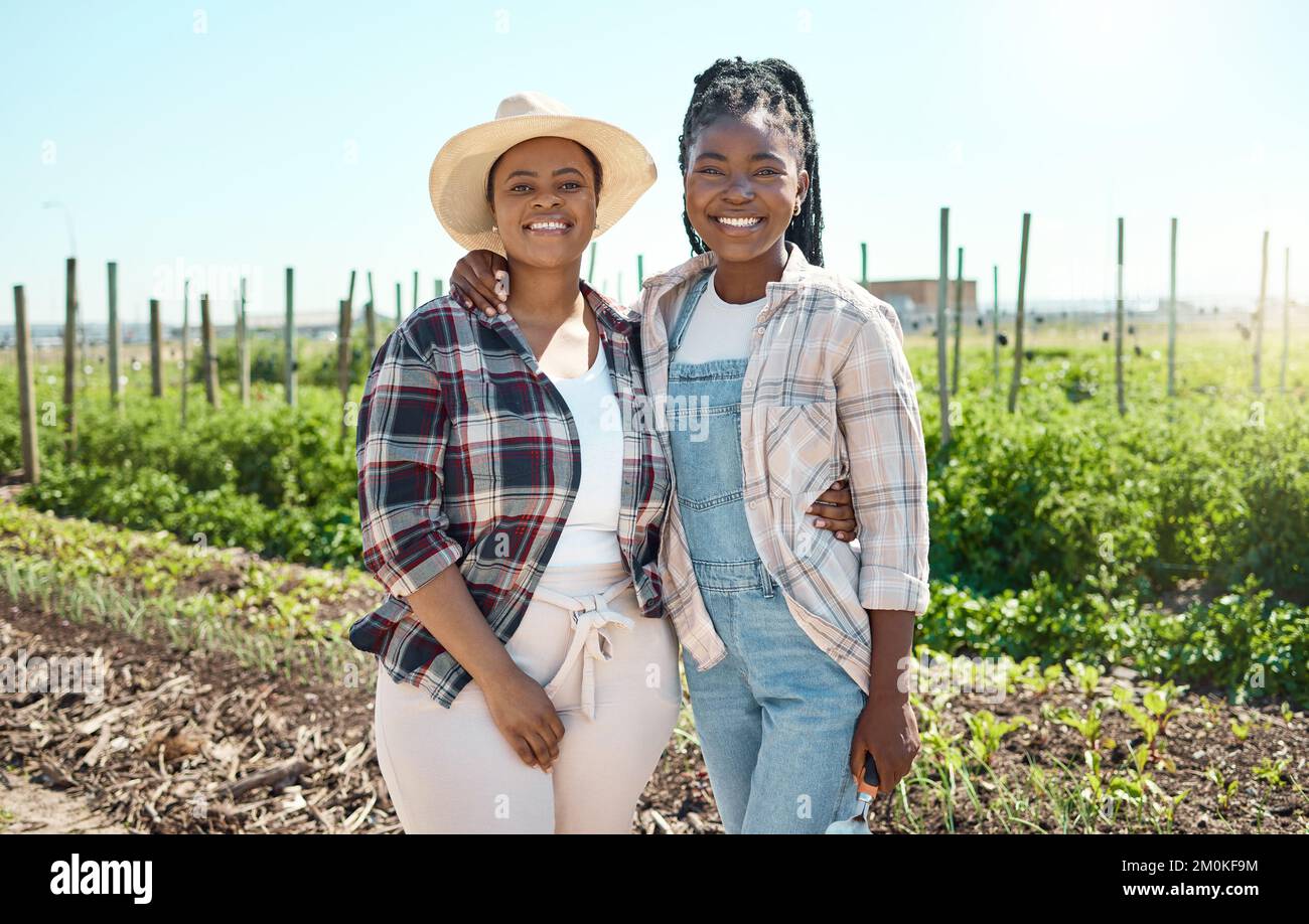 Young women working on a farm. Portrait of young farmers hugging. Women ...