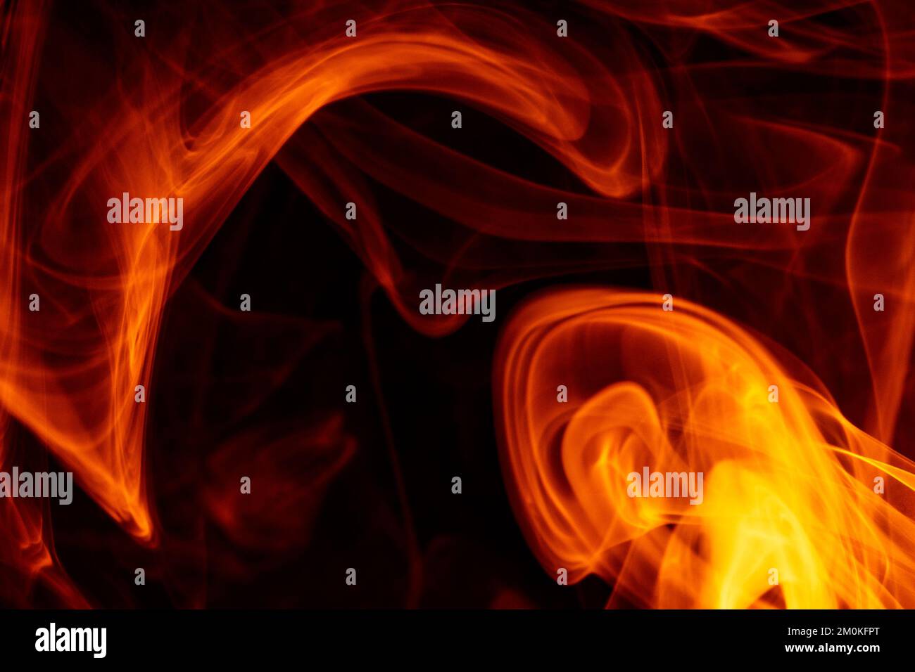A dramatic wallpaper of red smoke resembling fire flames on the black ...