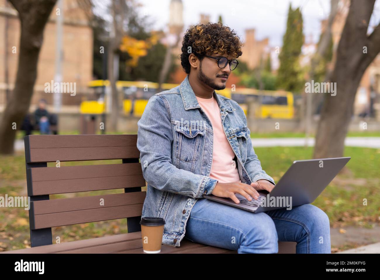 Indian sad and angry businessman in formal wear sitting on bench with ...