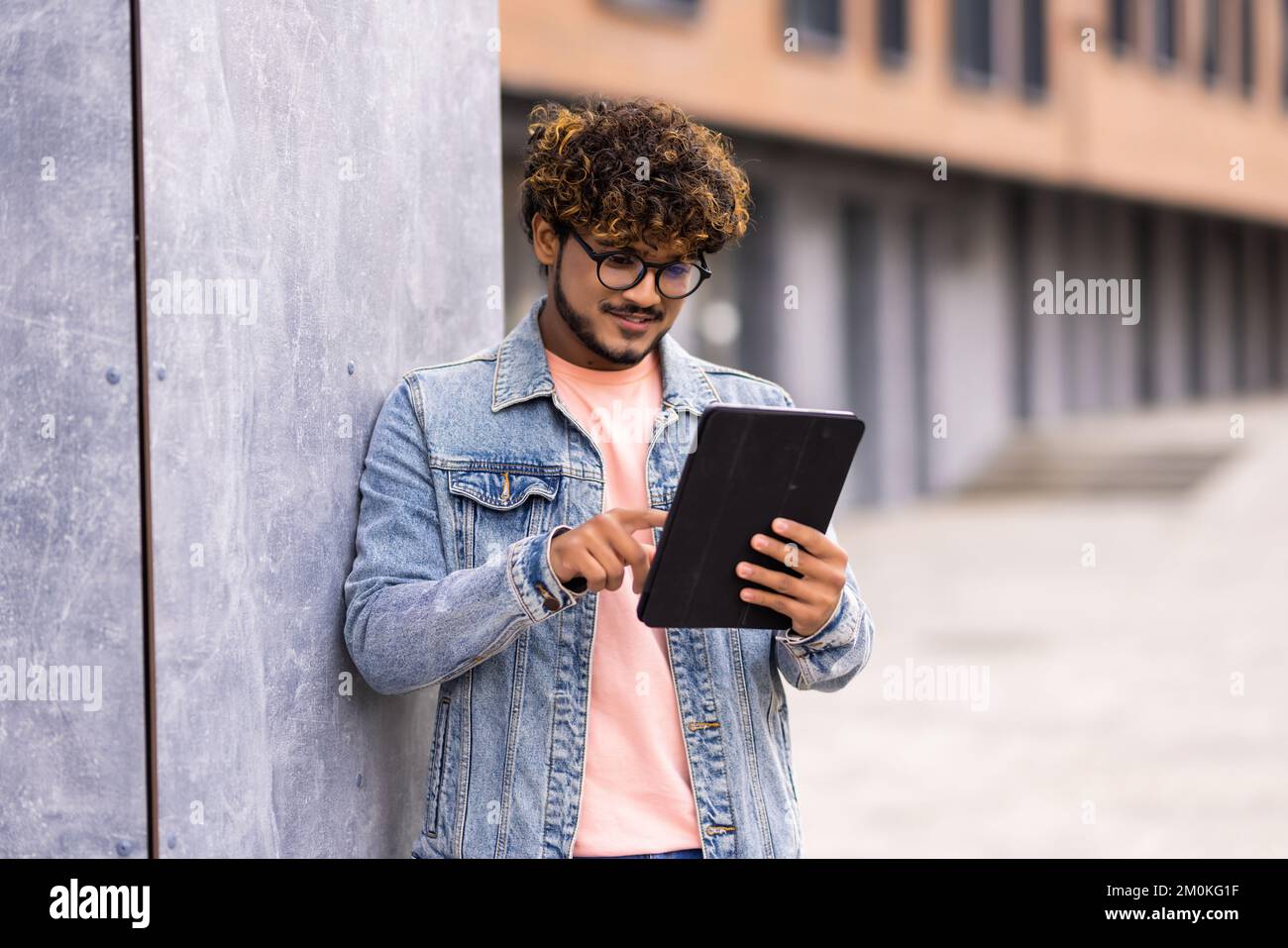 indian male using tablet outdoor Stock Photo - Alamy