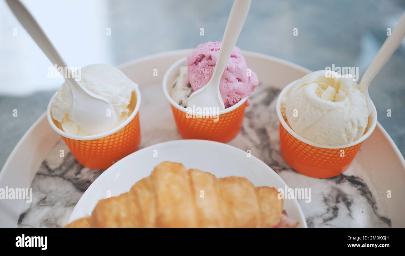 Ice cream and croissant with meat on the plate at the cafe Stock Photo ...