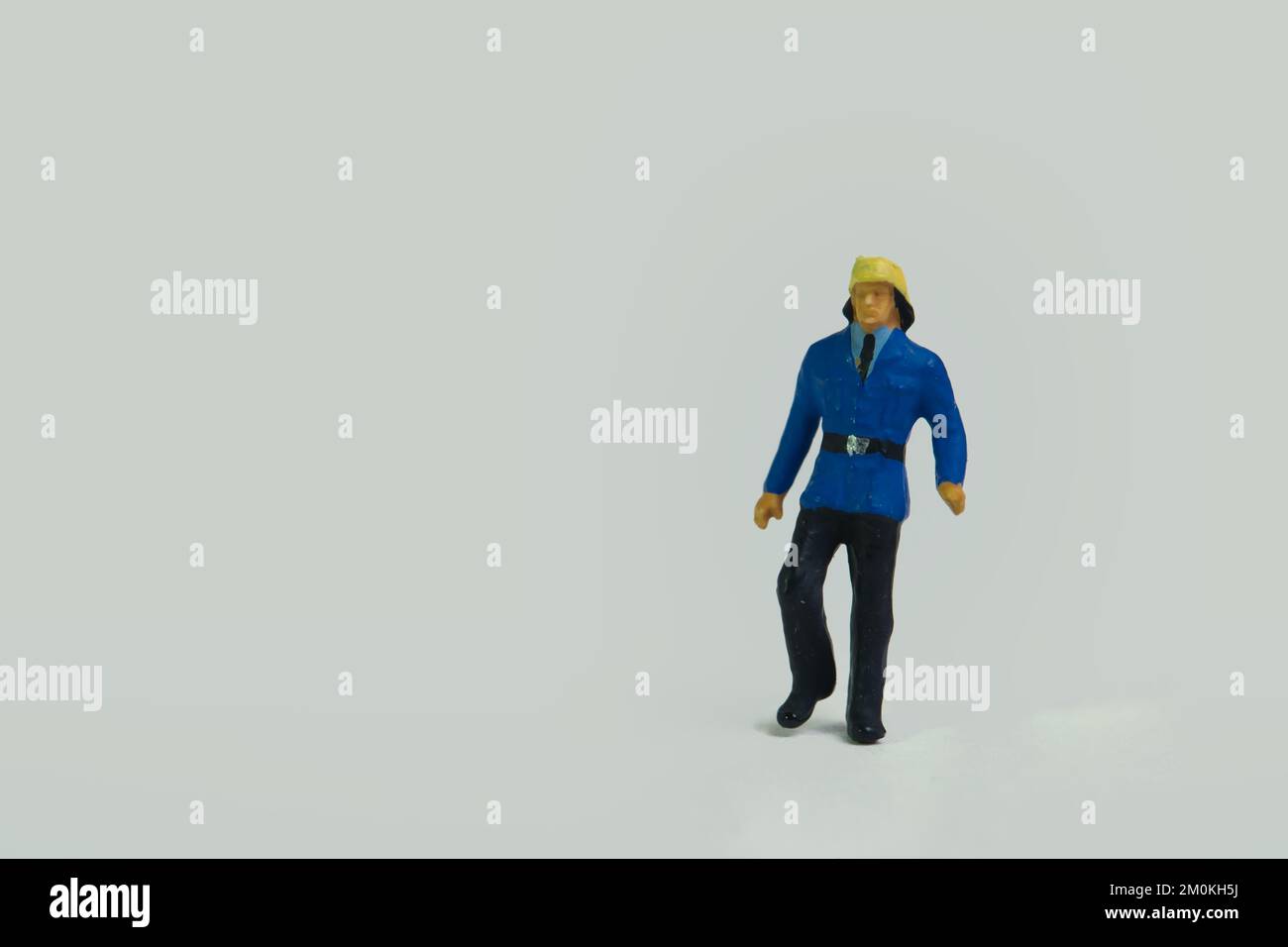 A miniature figure of a fireman standing on a white background Stock ...