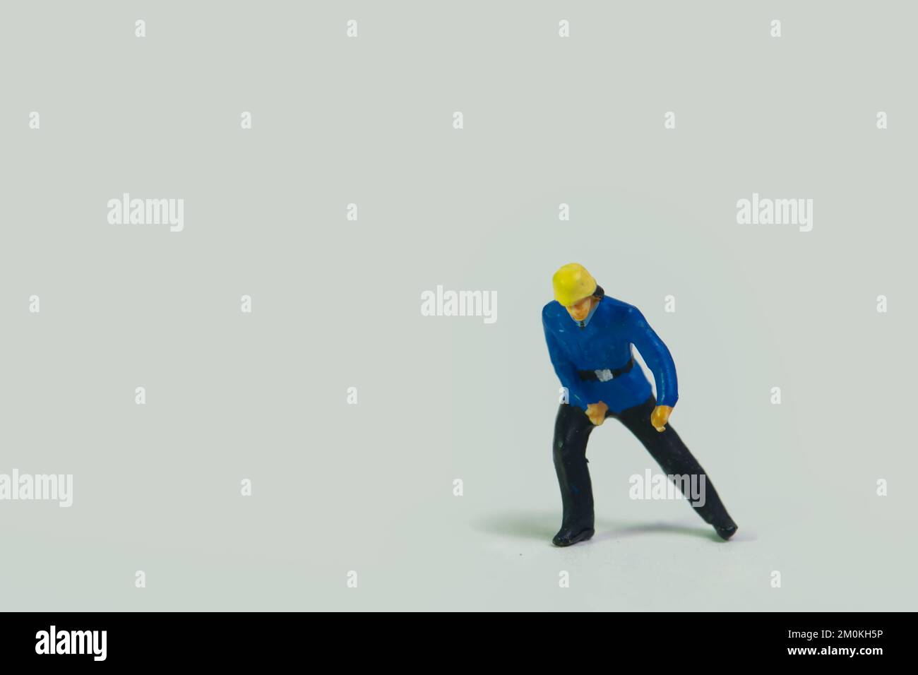A miniature figure of a fireman standing on a white background Stock ...