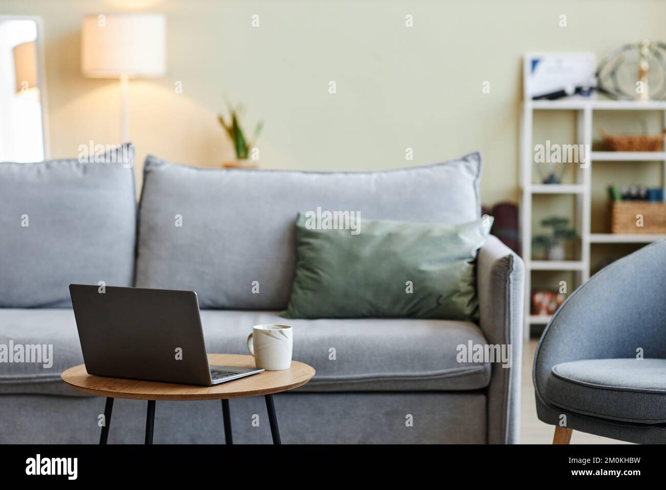 Close up of laptop on coffee table in stylish living room interior with ...
