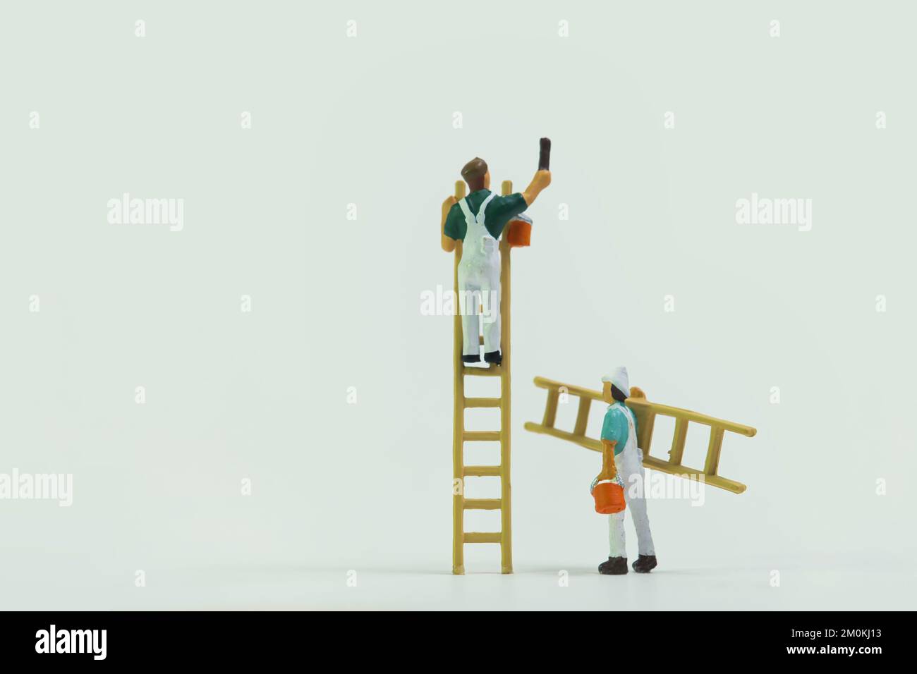 The miniature figures of construction workers painting the walls on a ...